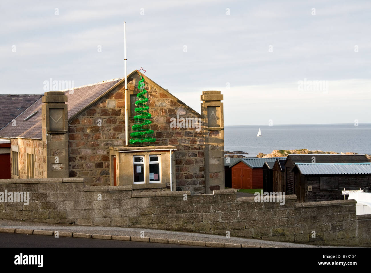 Small green Christmas tree atop the entrance to a primary school in ...