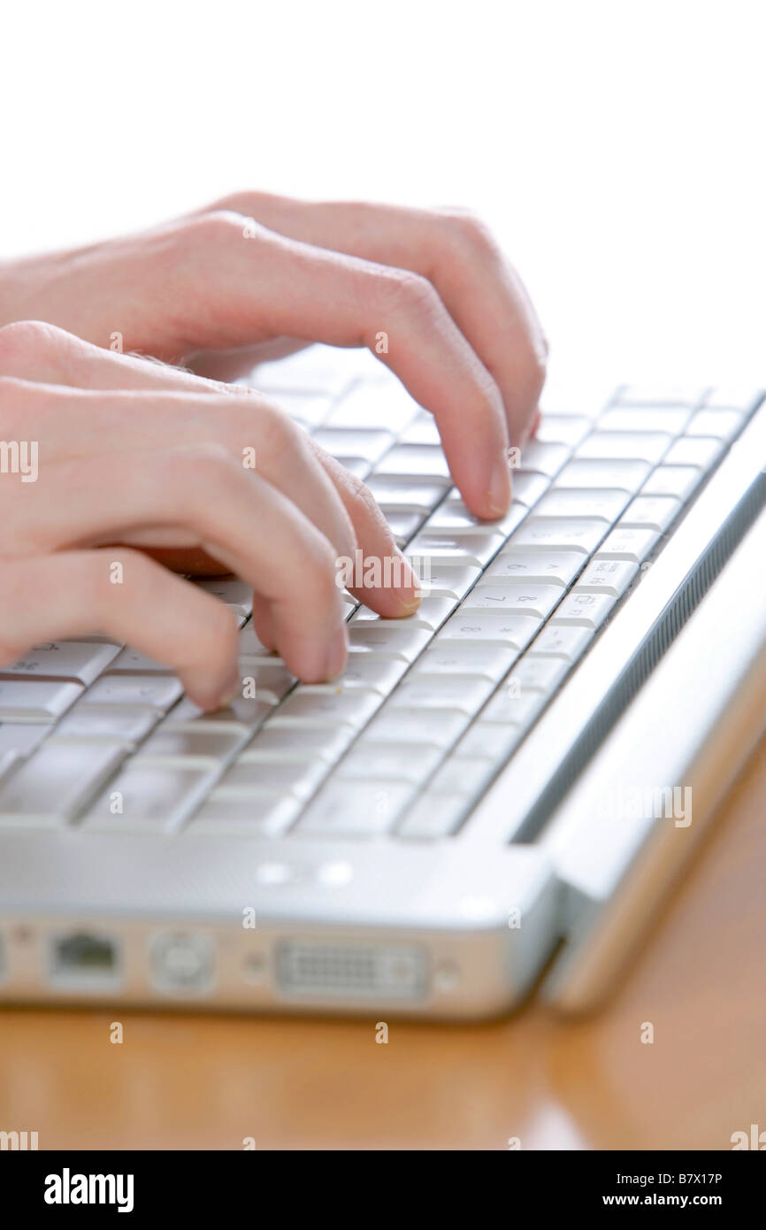 A person typing on a laptop keyboard Stock Photo - Alamy