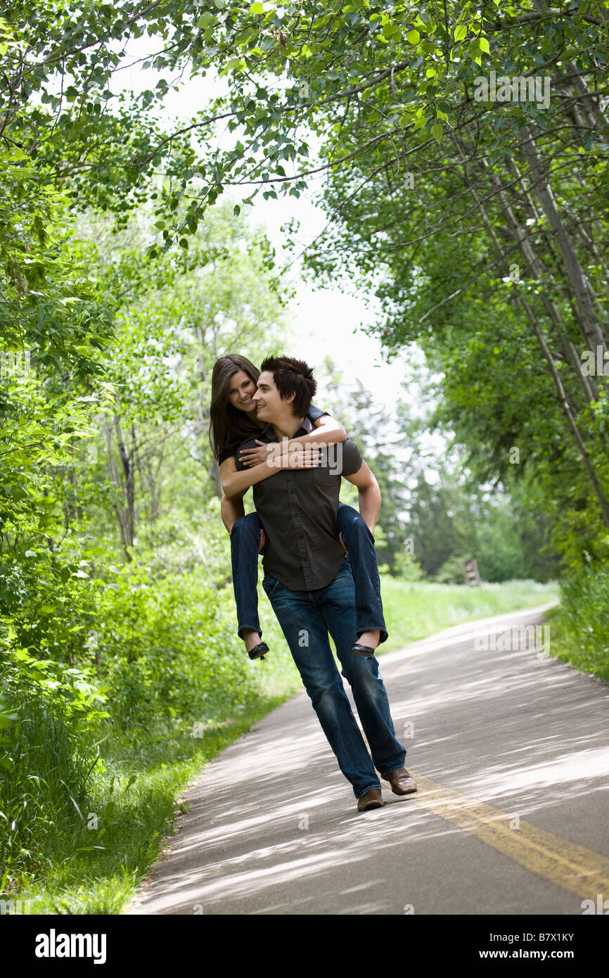 Man giving woman a ride on his back Stock Photo - Alamy