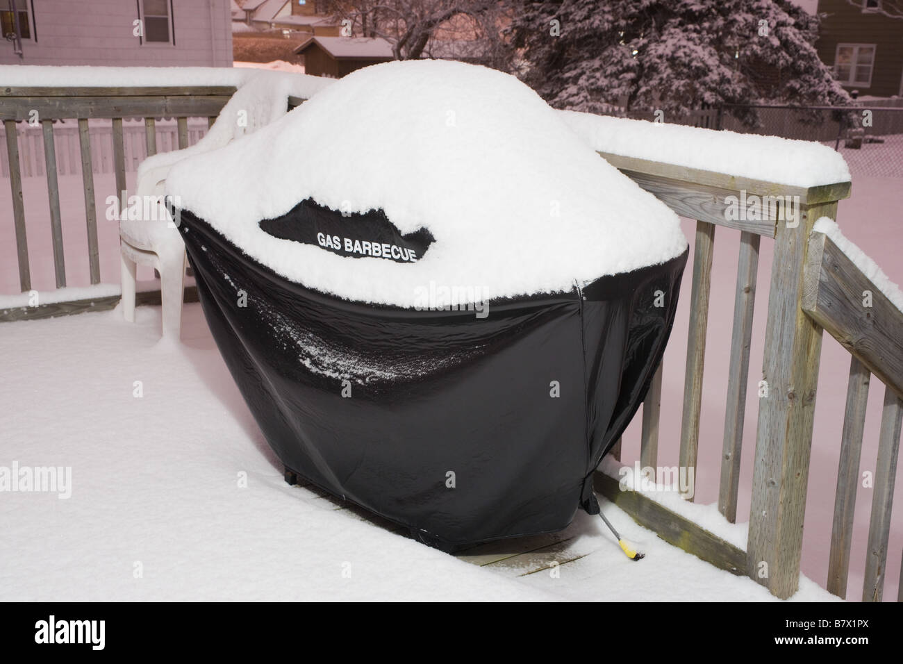 A snow covered barbeque sits on a deck in winter Stock Photo - Alamy