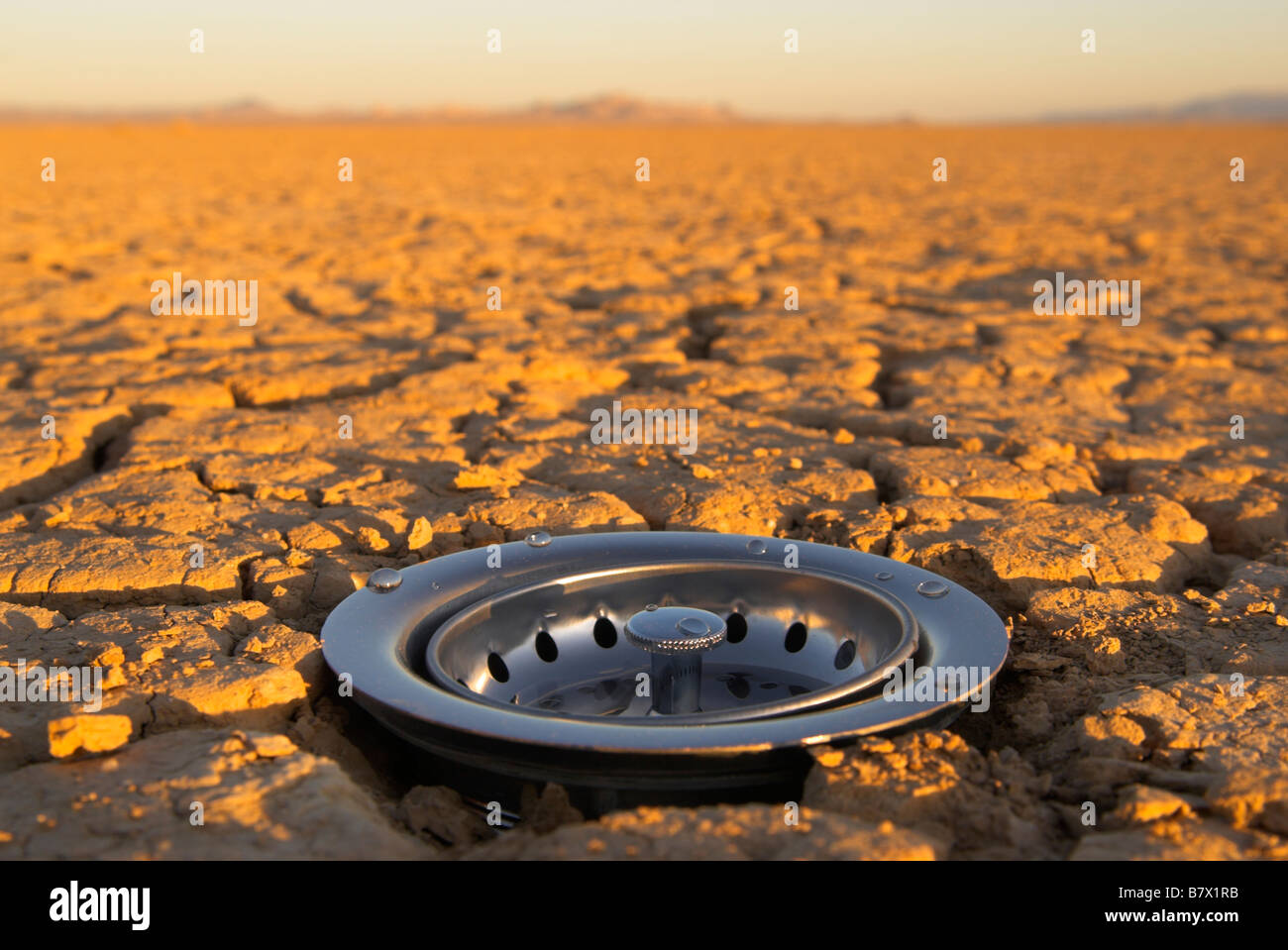 Sink drain on a dry lake bed, Mojave desert, California, USA. Photo Nov ...