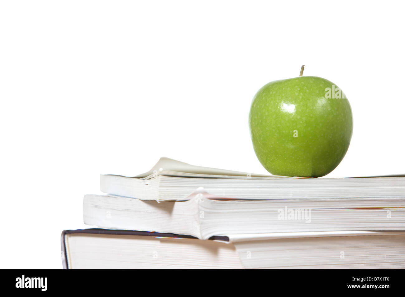 An apple on top of a stack of books Stock Photo - Alamy