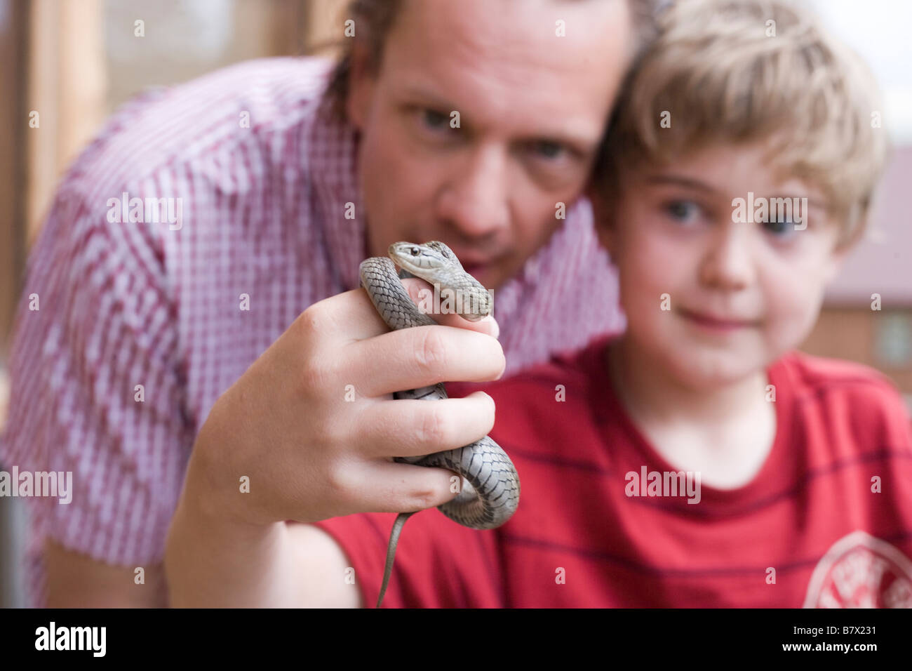 Child with snake hi-res stock photography and images - Alamy