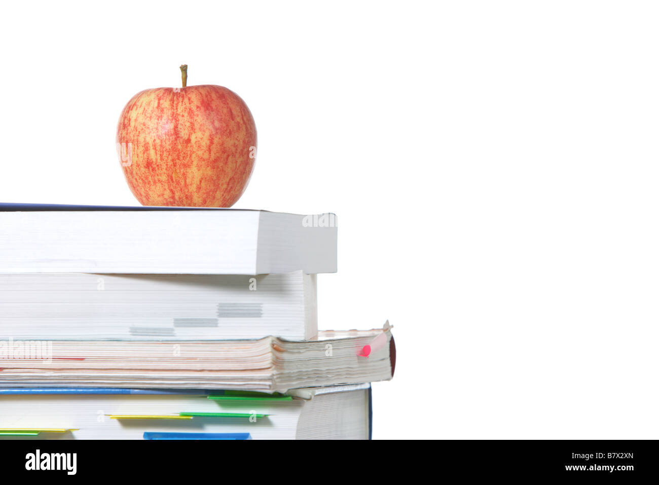 An apple on top of a stack of books Stock Photo - Alamy
