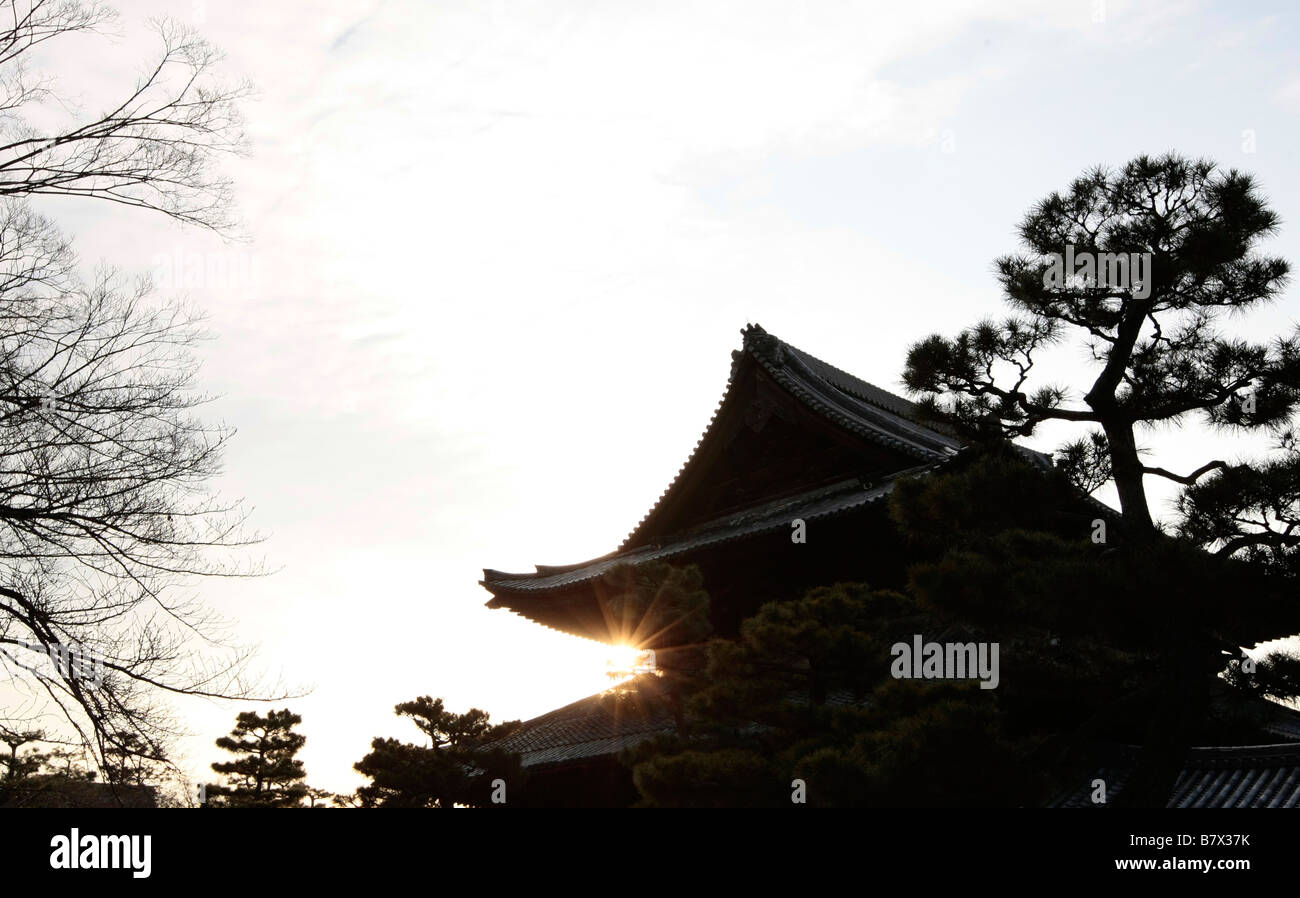 General view of the sun setting behind a building within the Shoren-In ...