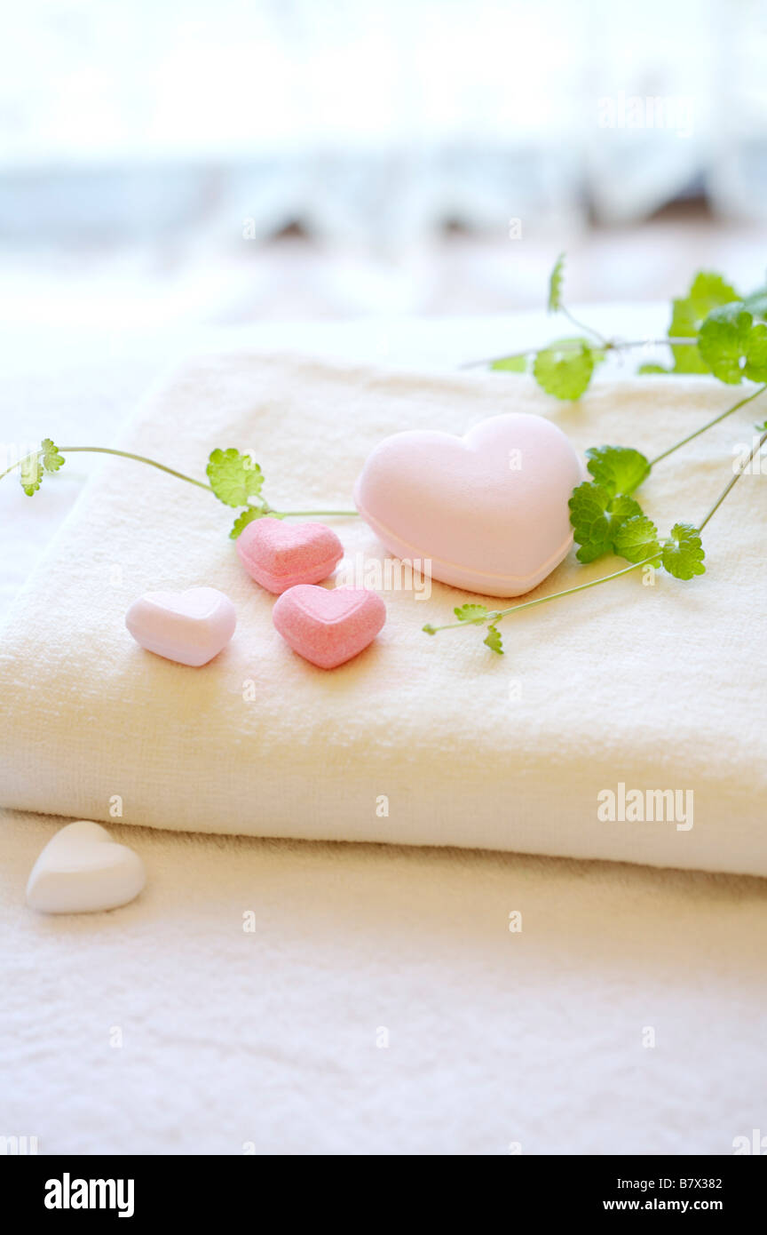 Folded towel with heart shapes on top Stock Photo - Alamy