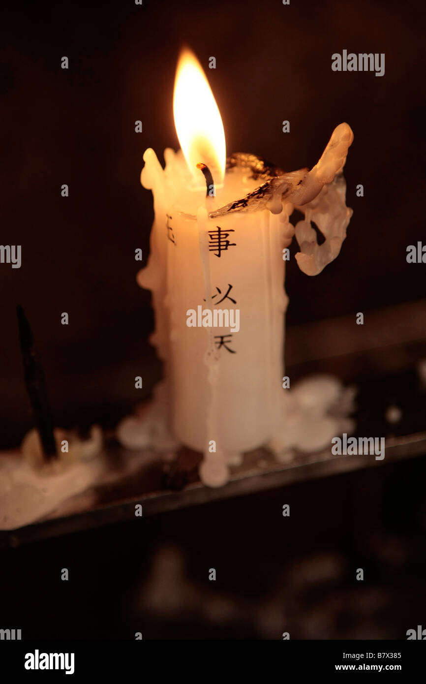 A candle burns at the Fushimi-Inari shrine in Kyoto, Japan Stock Photo ...