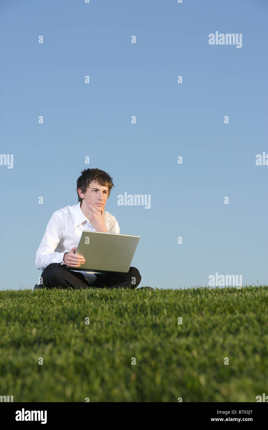 A Business man working outside in a park Stock Photo - Alamy