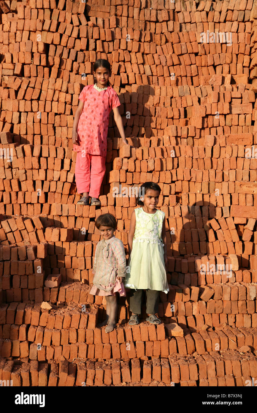 Children playing on pile of bricks Jahukhel Stock Photo - Alamy
