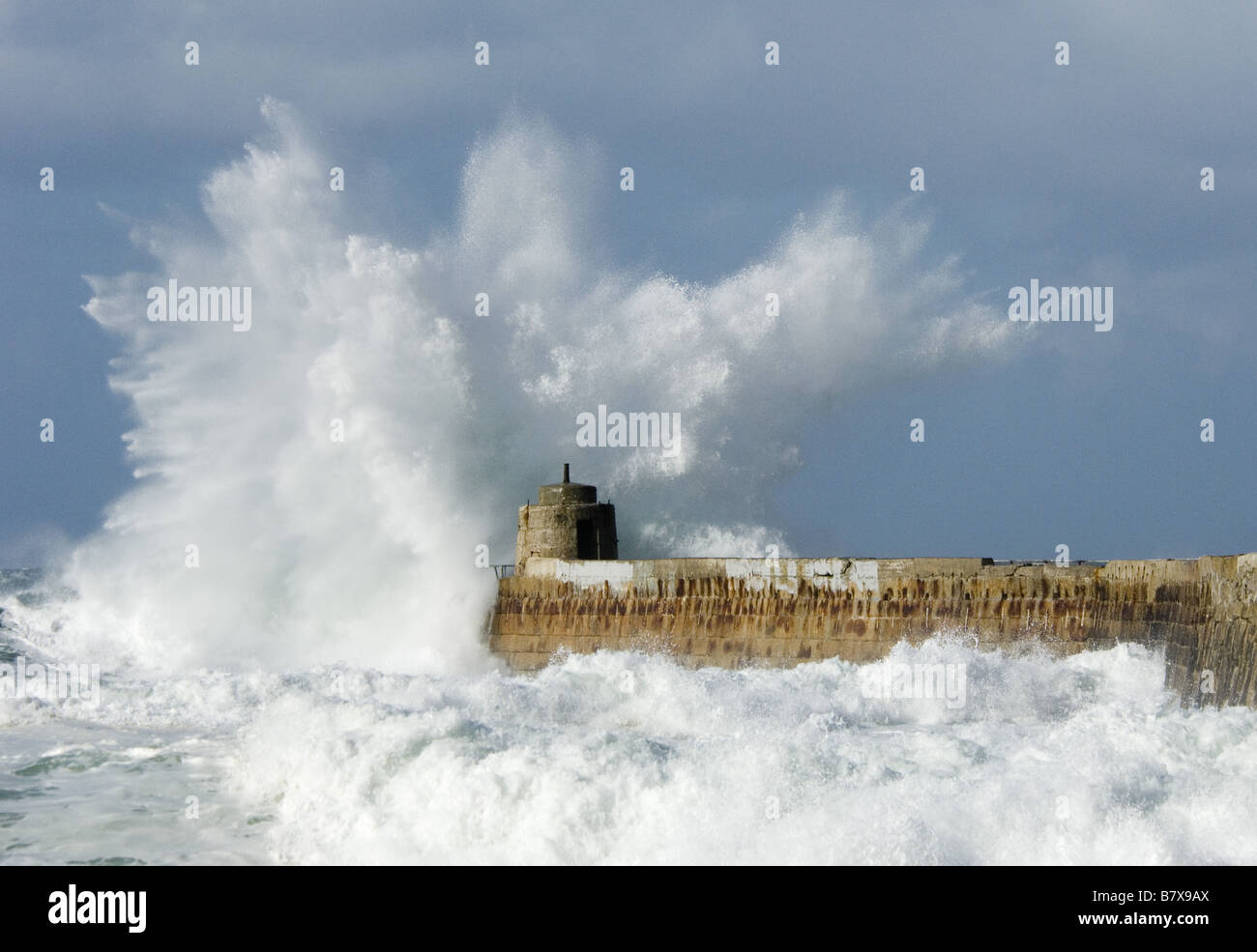 Stormy Atlantic seas batter the harbour wall of the Cornish village of ...
