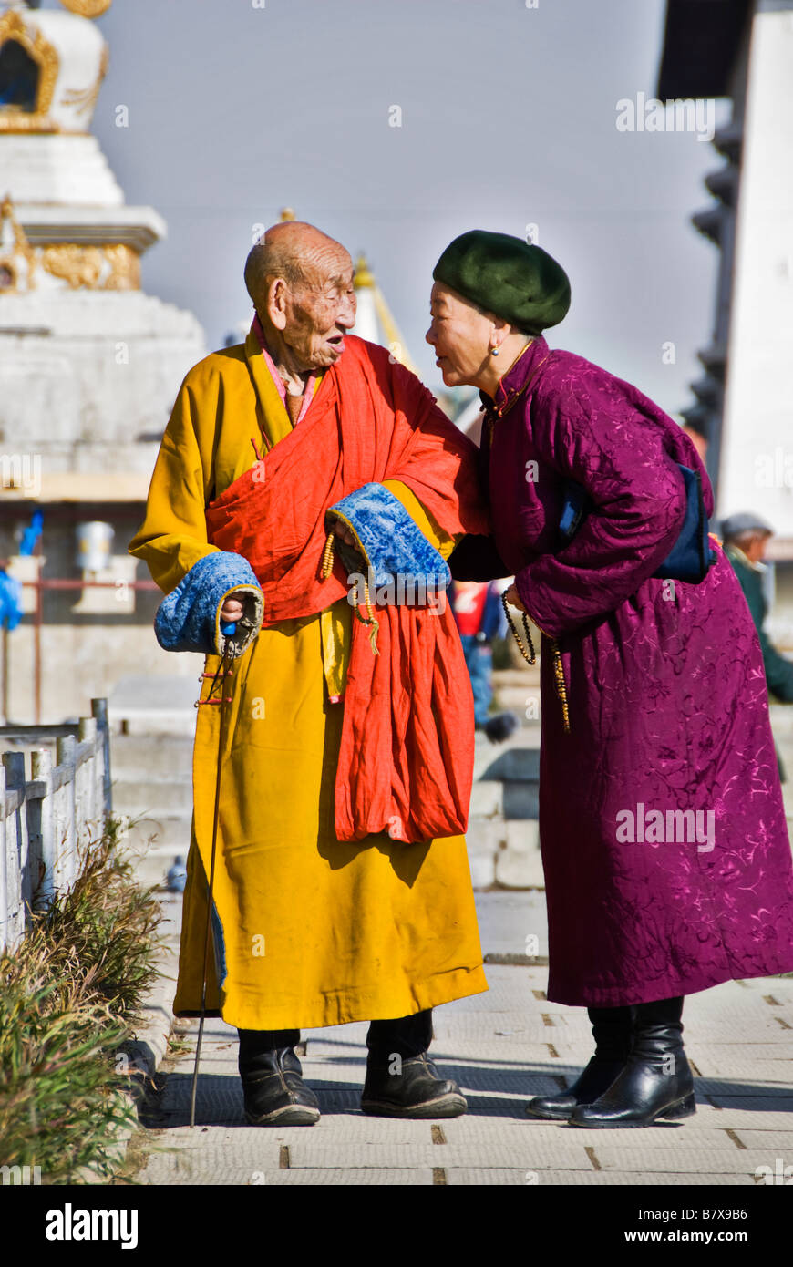 Woman talking to a Buddhist monk at the Gandantegchinlen Khiid ...