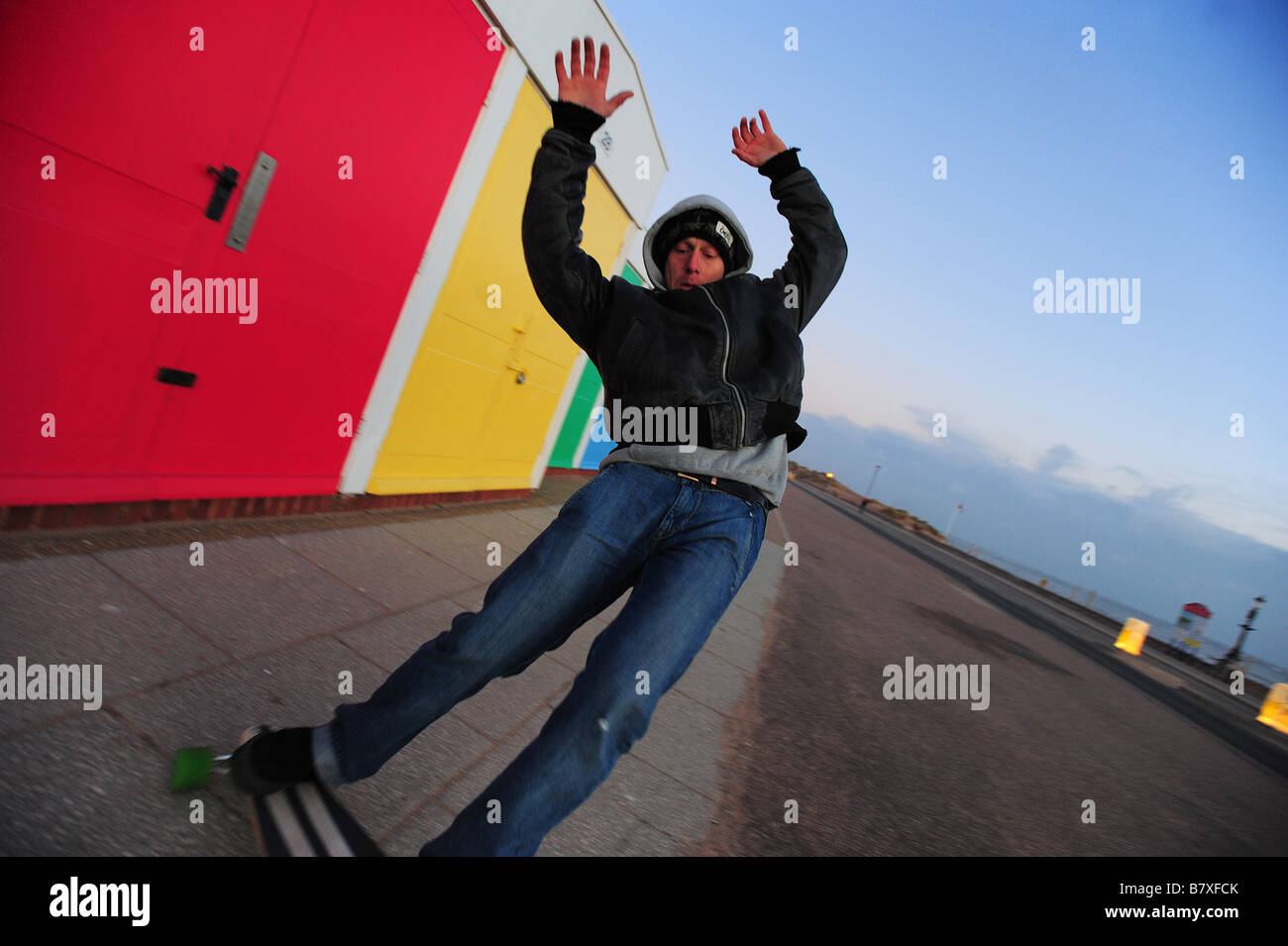 a man riding a carveboard skateboard on the promenade at Exmouth, Devon ...