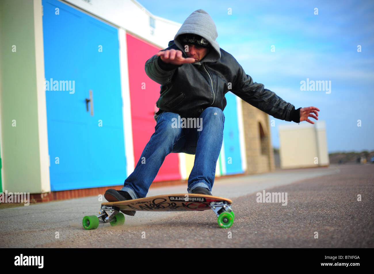 a man riding a carveboard skateboard on the promenade at Exmouth, Devon ...