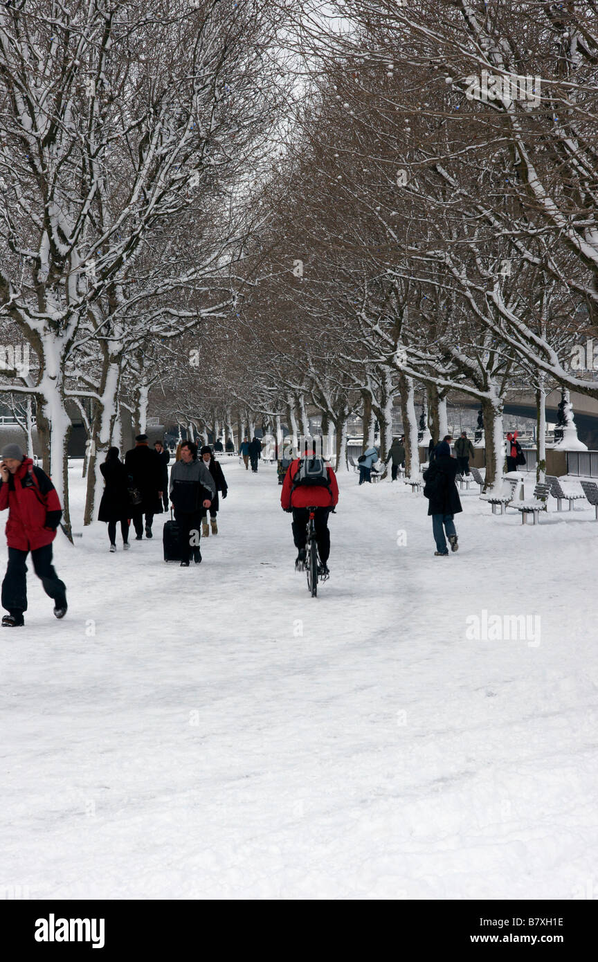 Commuters Facing The Snow on the Southbank Stock Photo - Alamy