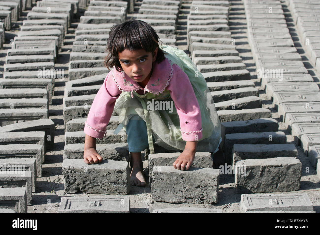 Six year old girl turning bricks brick factory Nepal Stock Photo - Alamy