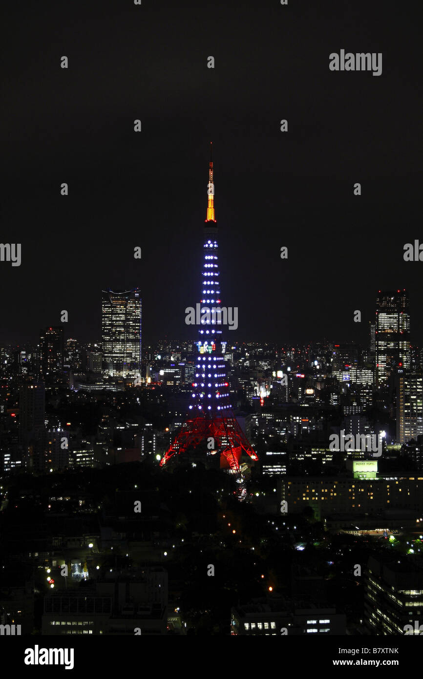 Against the backdrop of Tokyo s skyscrapers and night sky Tokyo Tower ...