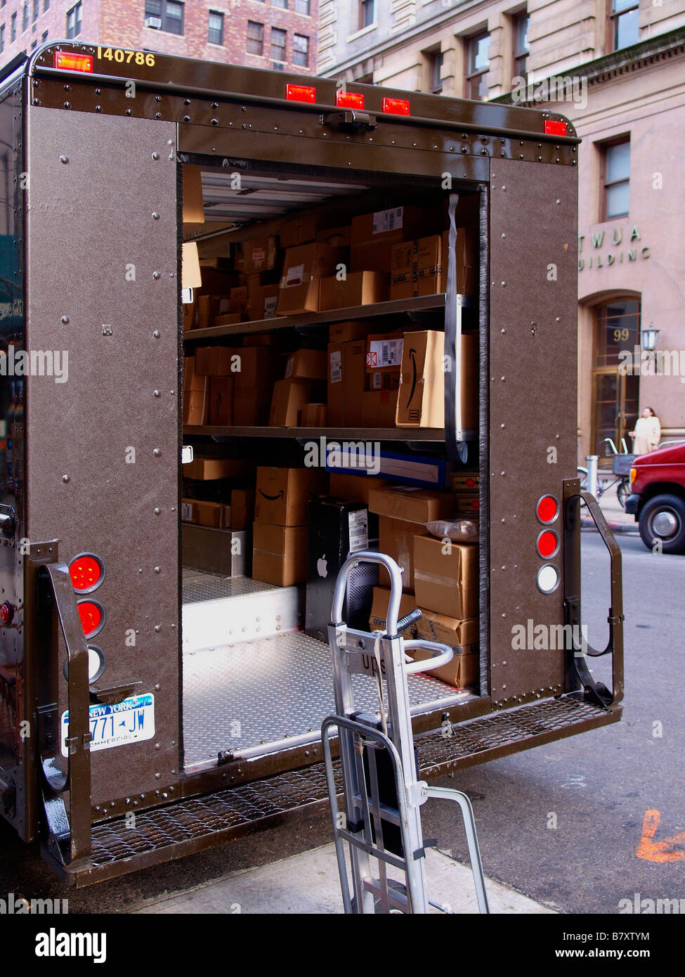 Hand truck at the rear of an open parcel delivery truck in New York ...