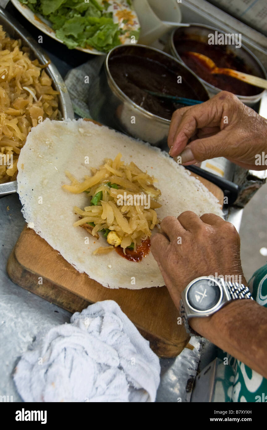Hawker preparing fresh spring roll in the streets of Melaka, Malaysia ...