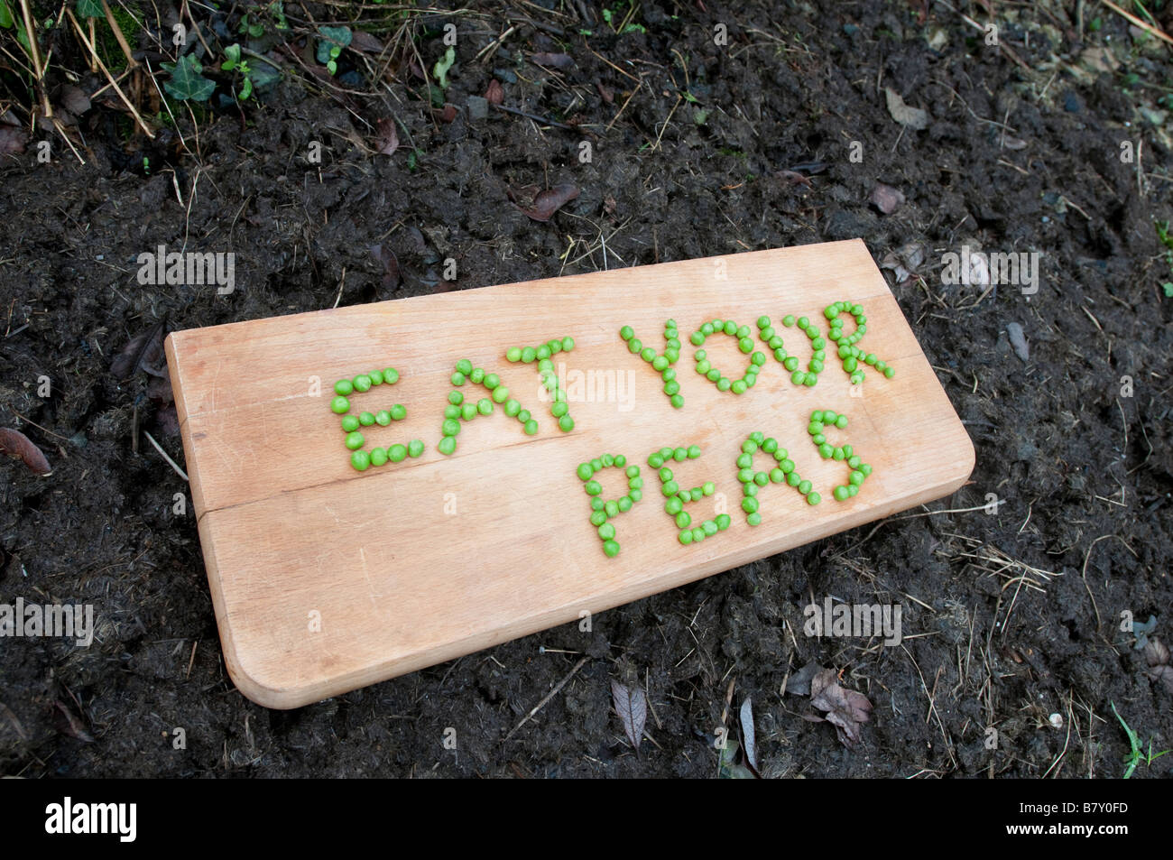 Eat your peas spelt out in peas on a chopping block Stock Photo - Alamy