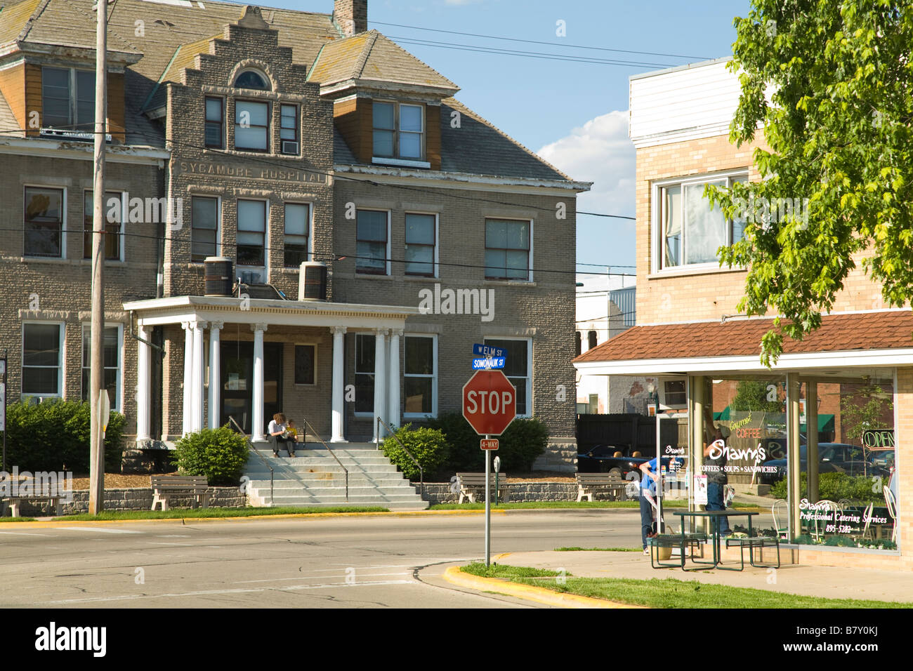 ILLINOIS Sycamore Man wash windows of cafe restaurant in small town ...