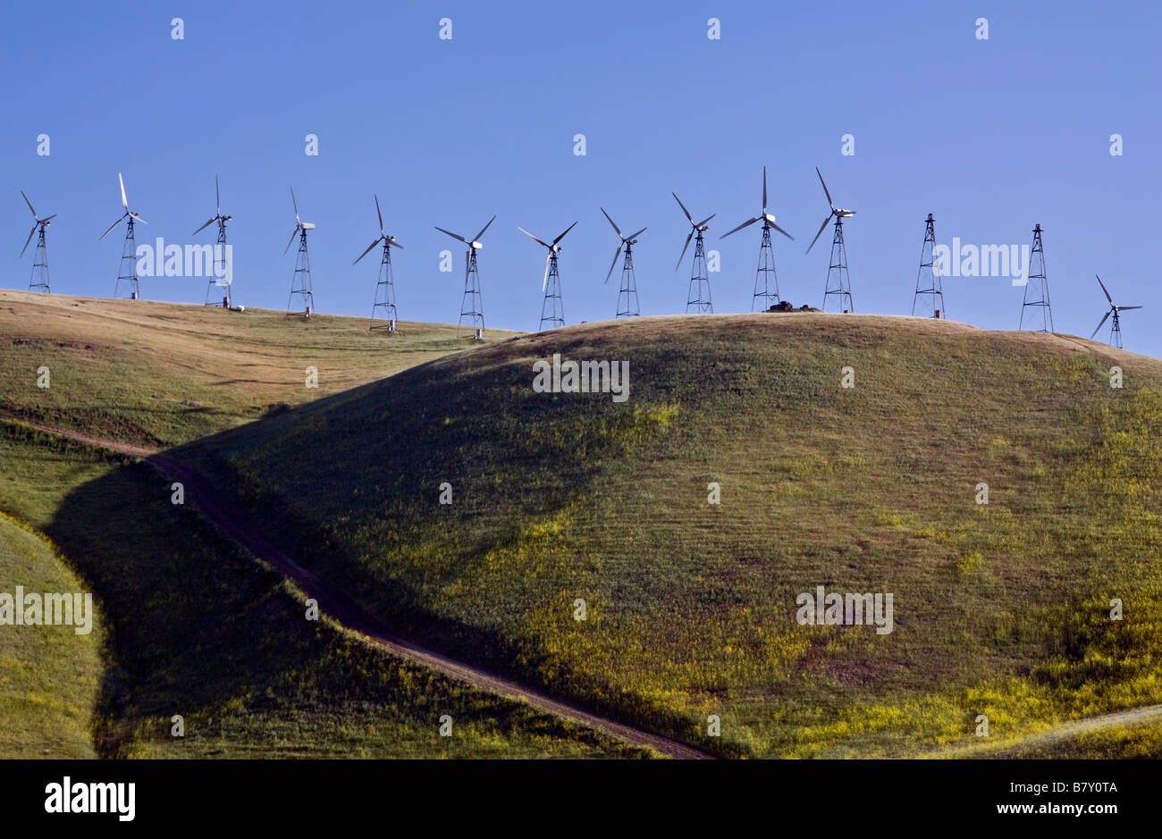 Wind turbines up on the hills in the late afternoon Stock Photo - Alamy