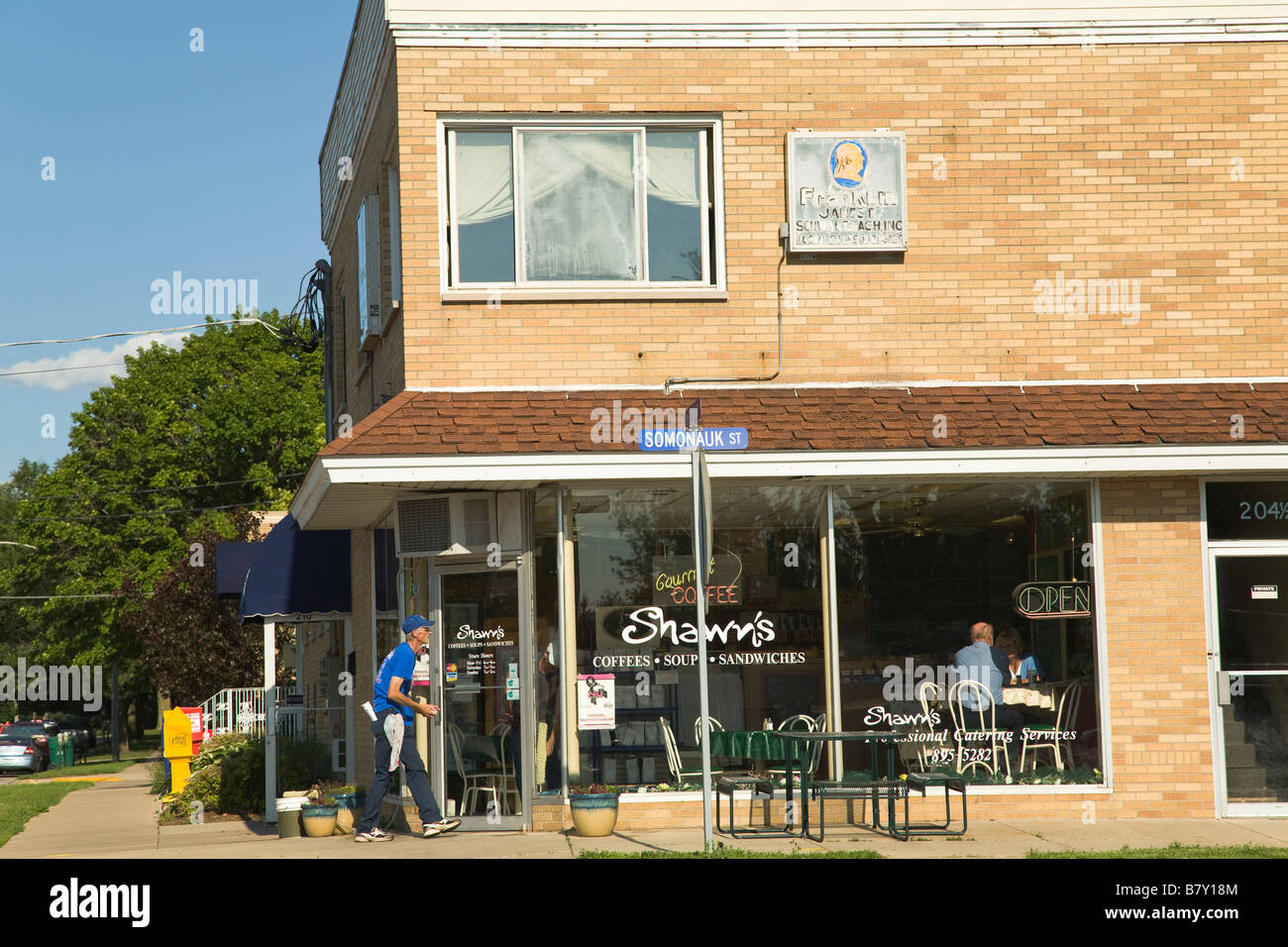 ILLINOIS Sycamore Man wash windows of cafe restaurant in small town ...