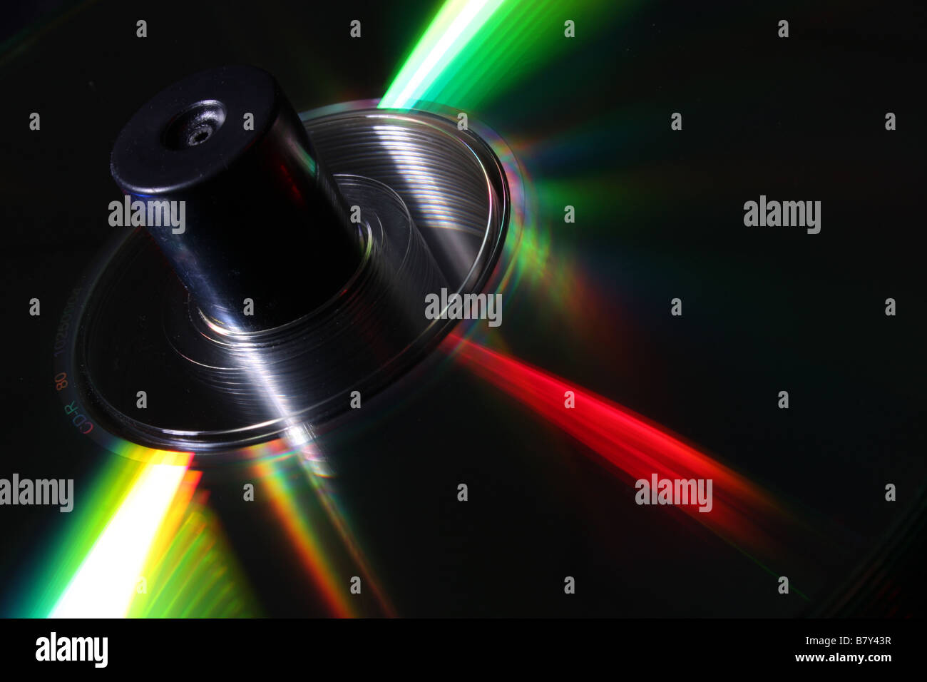 Stack of CD's on a spindle lit with coloured lighting Stock Photo - Alamy