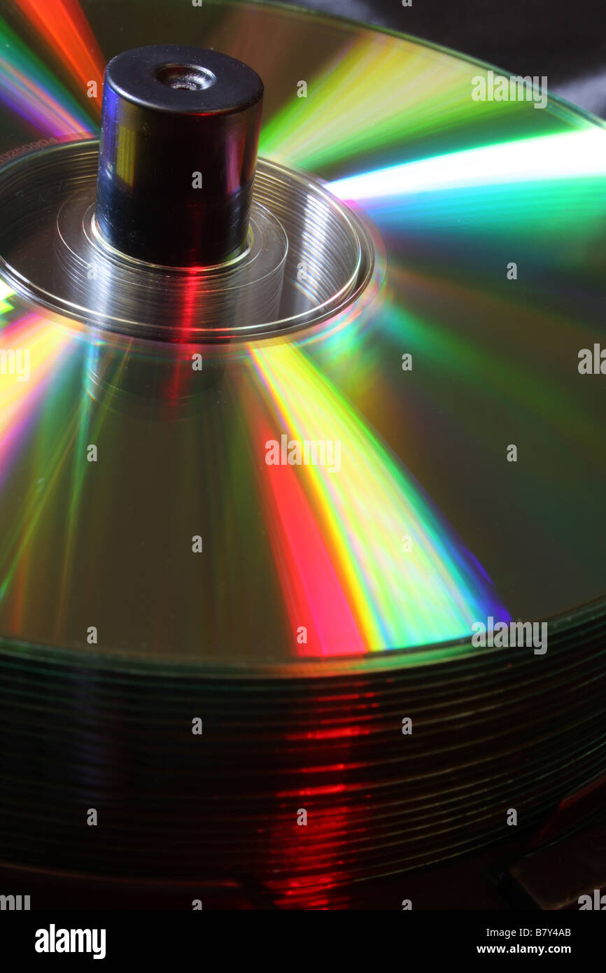 Stack of CD's on a spindle lit with coloured lighting Stock Photo - Alamy