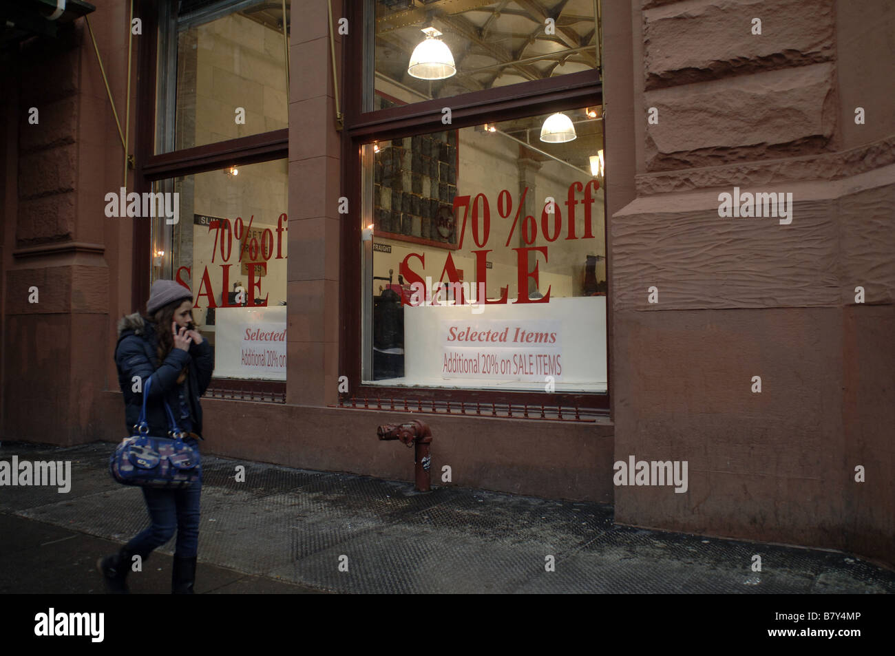 Shoppers pass the Atrium clothing boutique in the New York neighborhood ...