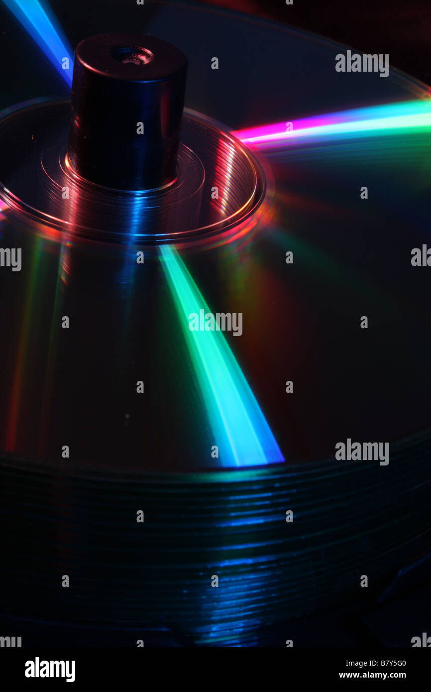 Stack of CD's on a spindle lit with coloured lighting Stock Photo - Alamy