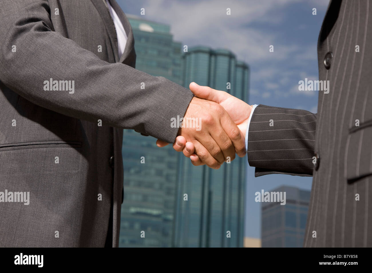 Two businessmen shaking hands Stock Photo - Alamy