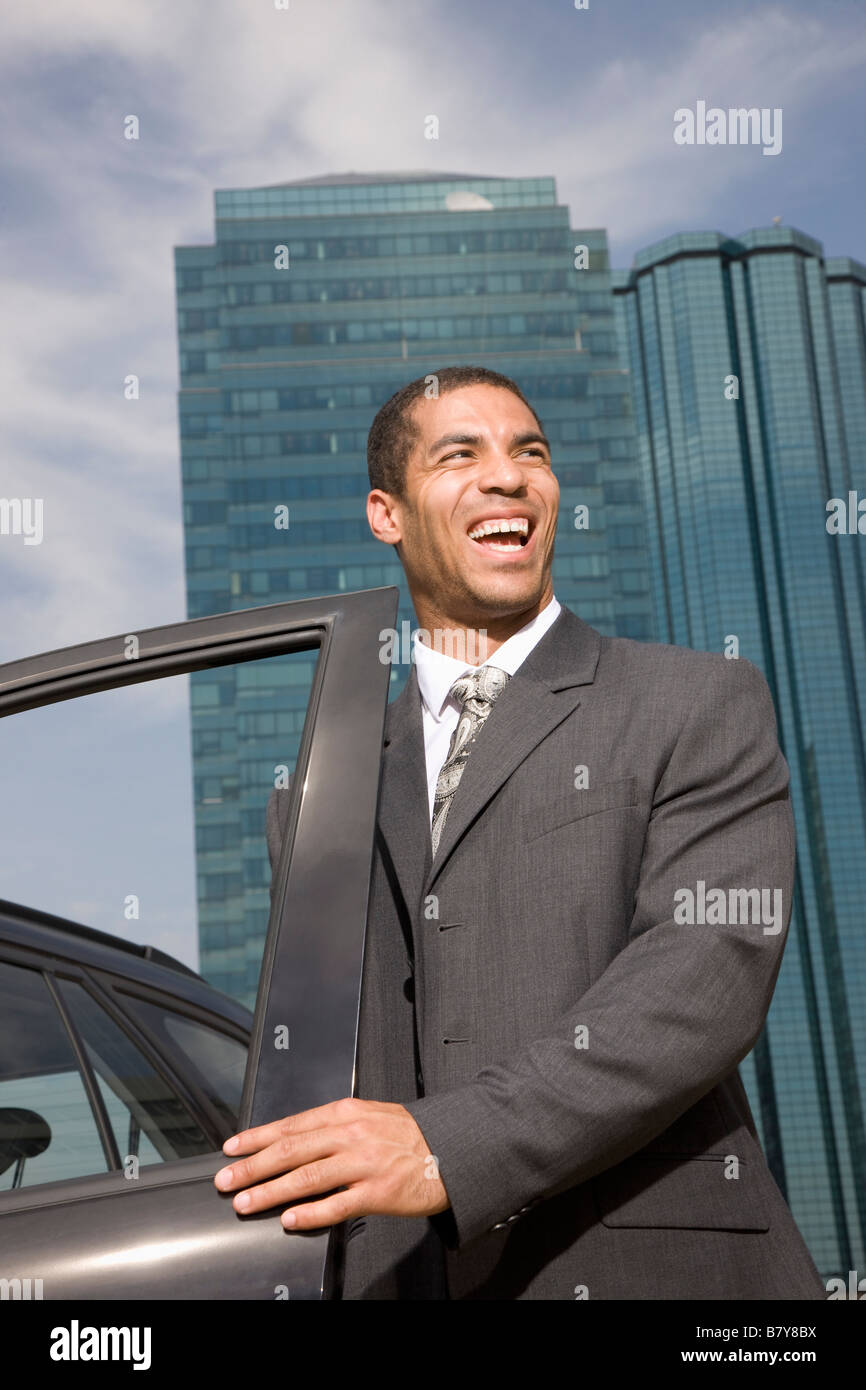 Businessman getting in car Stock Photo - Alamy