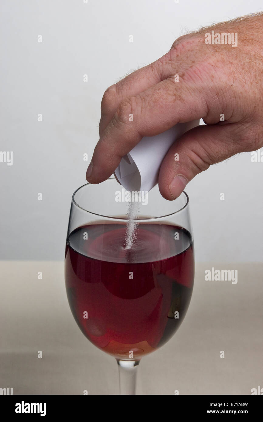 Spiking of red wine drink with suspicious substance Stock Photo - Alamy