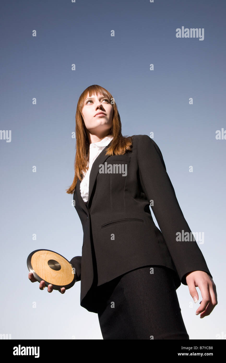 Businesswoman holding a discus Stock Photo - Alamy
