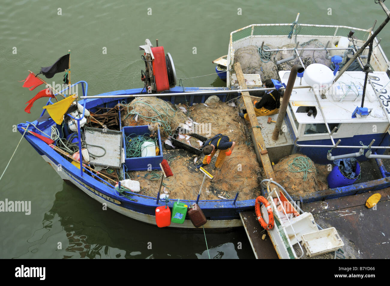 French fisherman and fishing boat at the port of Boulogne-sur-Mer ...