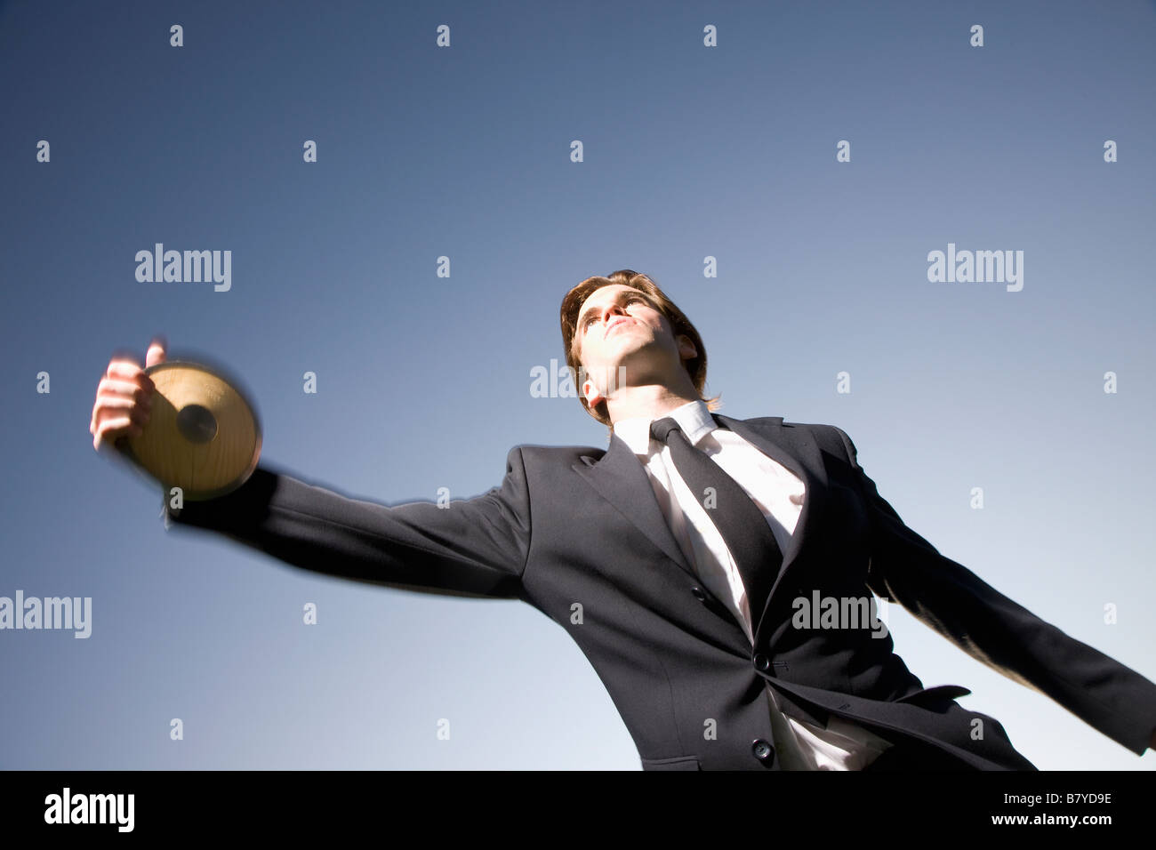 Businessman throwing a discus Stock Photo - Alamy