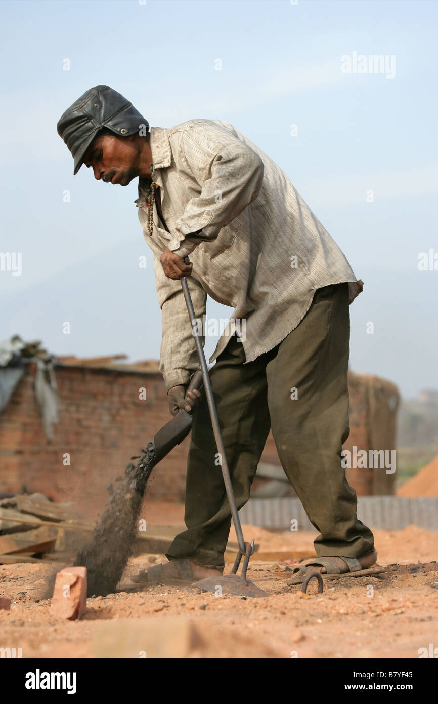 Indian man firing hand made bricks Nepal Stock Photo - Alamy