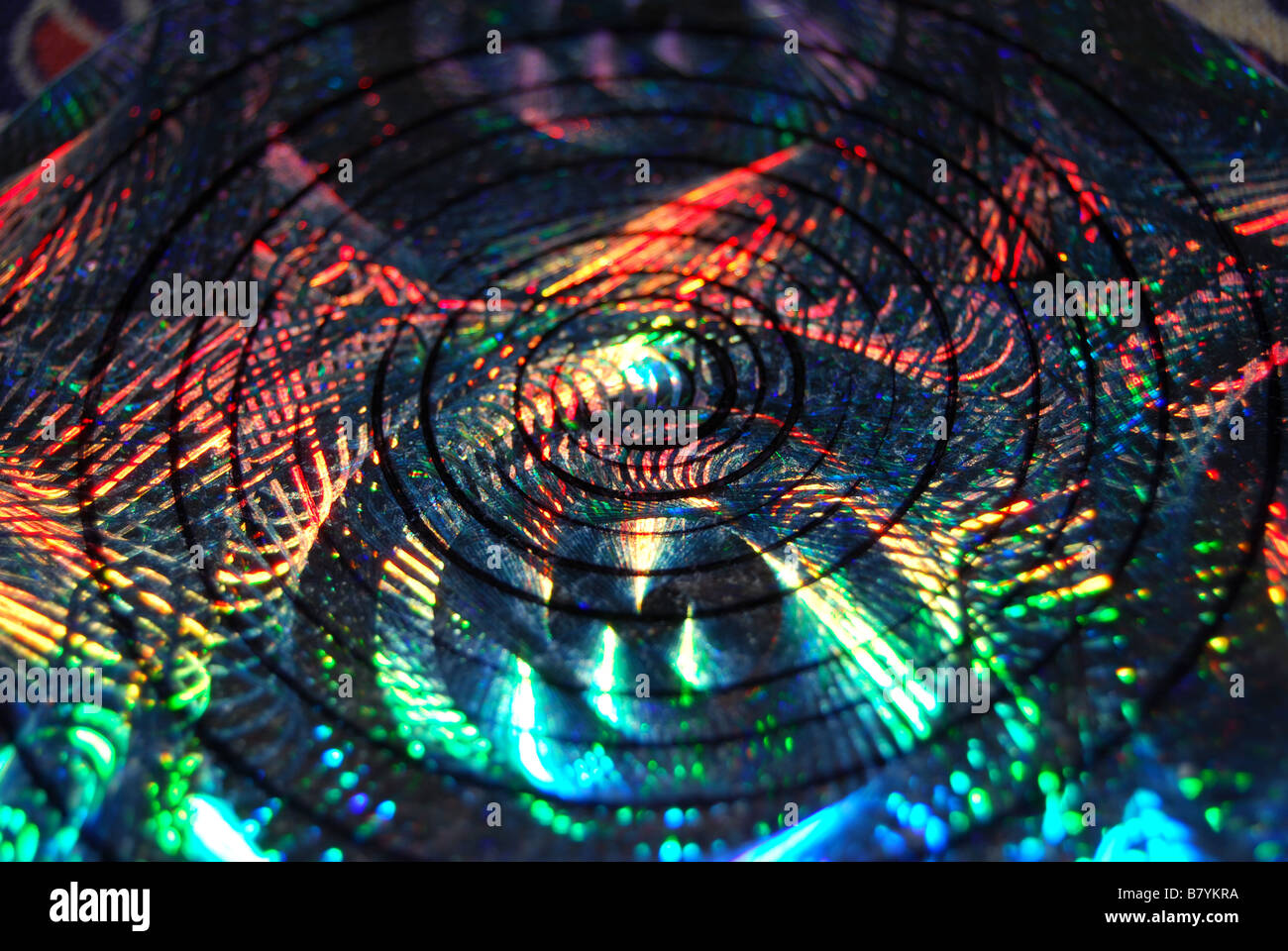 multi coloured neon looking reflected lights on a laser disc with a ...