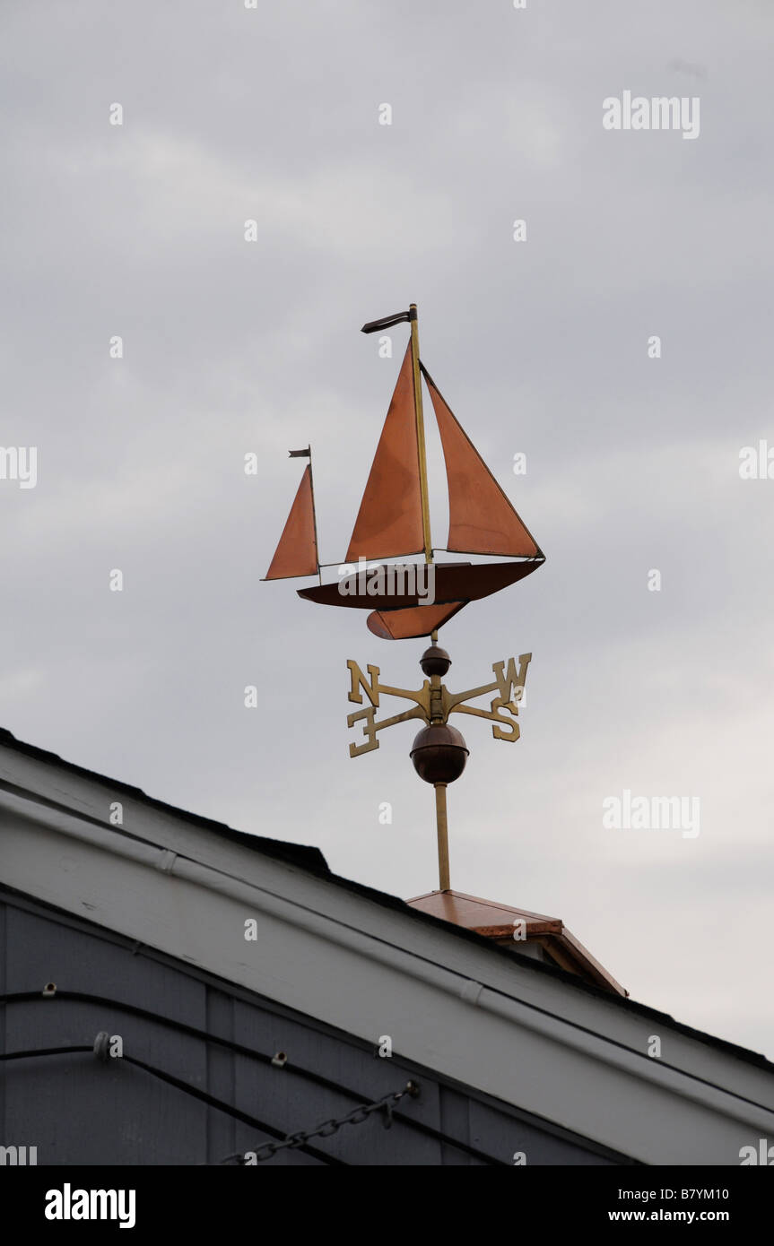 Boat shaped Weather vane on roof Stock Photo - Alamy