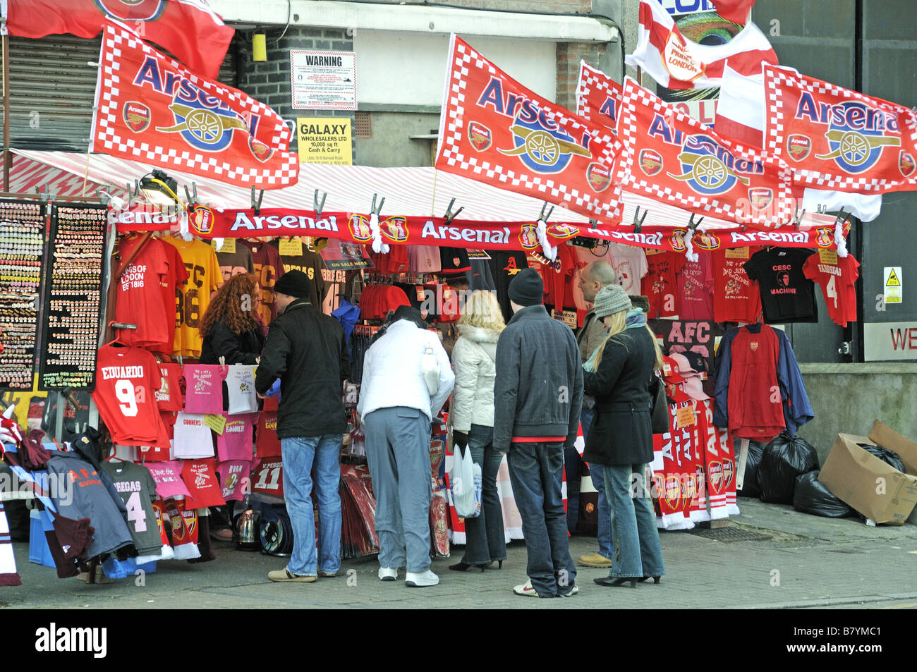 People , fans crowding round stall selling Arsenal merchandise Holloway ...