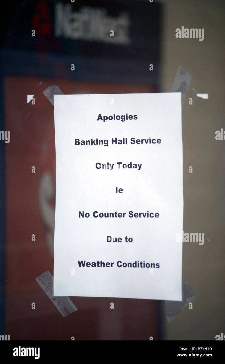 A sign in a bank window apoligising for no counter service due to bad ...