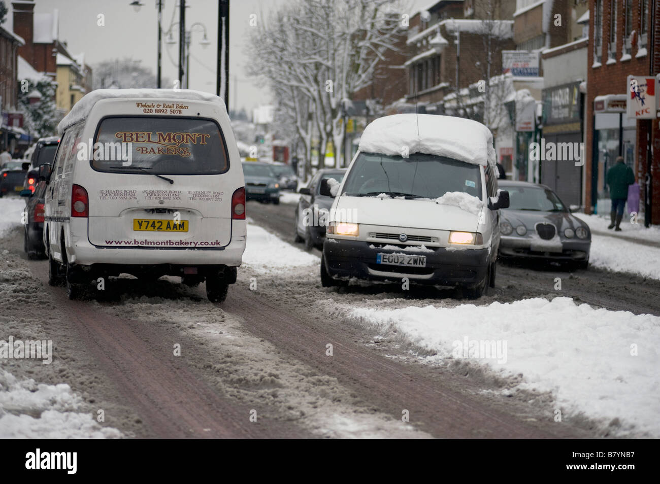Two vans in heavy snow on a busy high street Stock Photo - Alamy