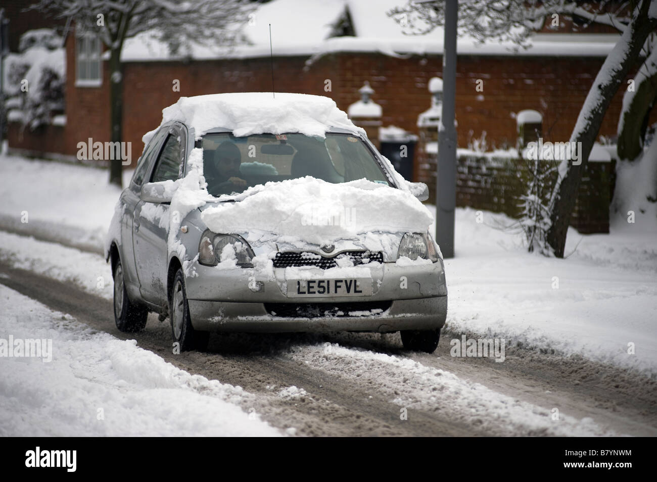 Car driving slowly street hi-res stock photography and images - Alamy