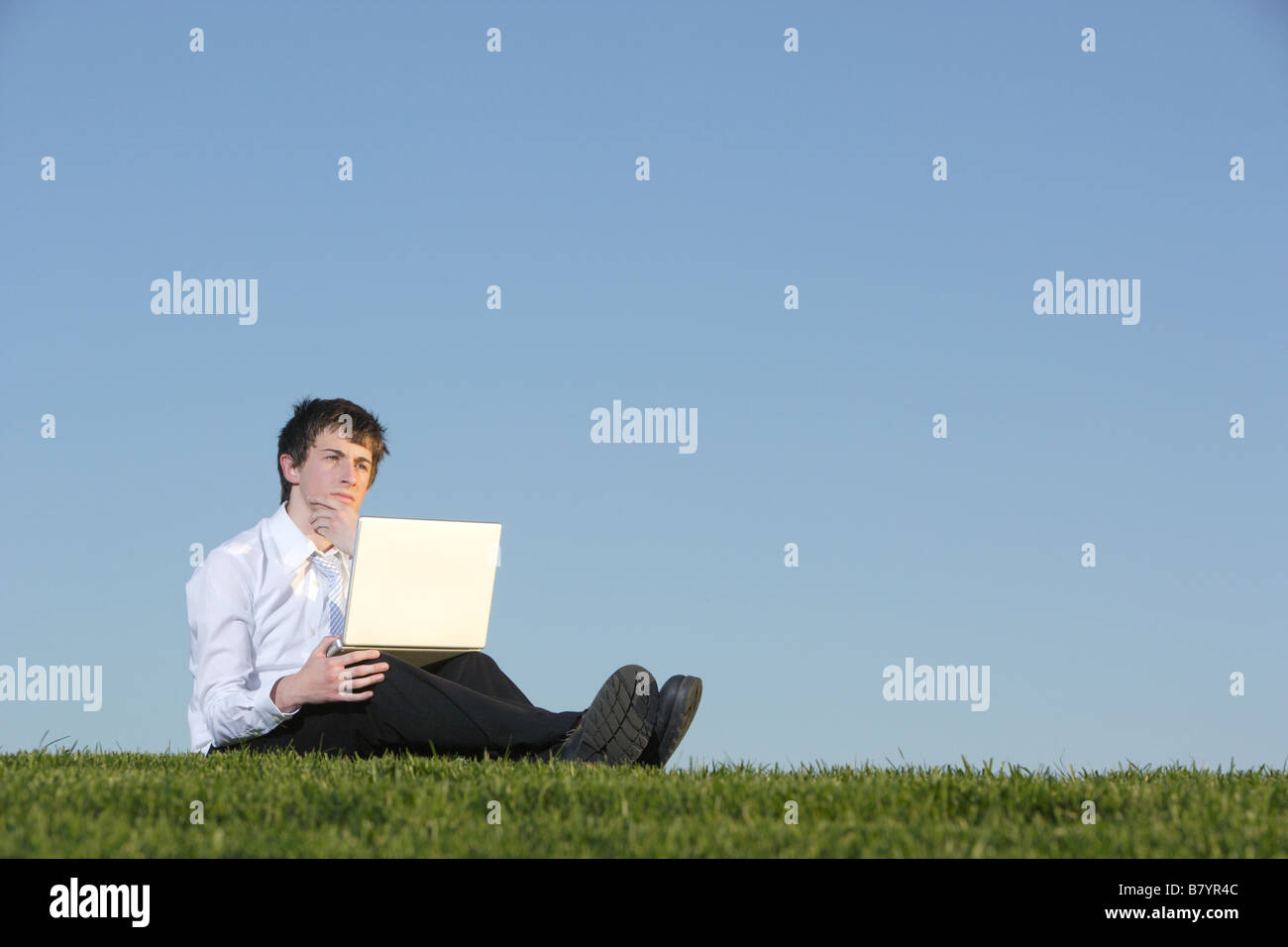 A Business man working outside in a park Stock Photo - Alamy