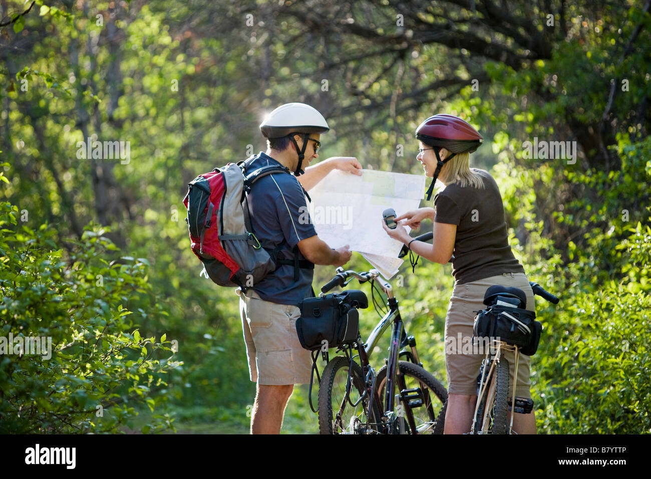 Two bikers looking at a map Stock Photo - Alamy