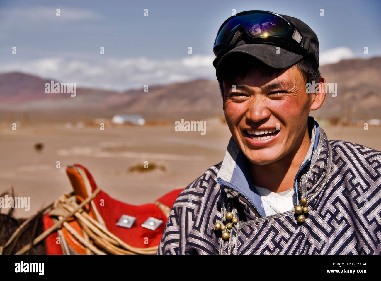 Young Mongolian man dressed in a traditional way smiling Mongolia Stock ...