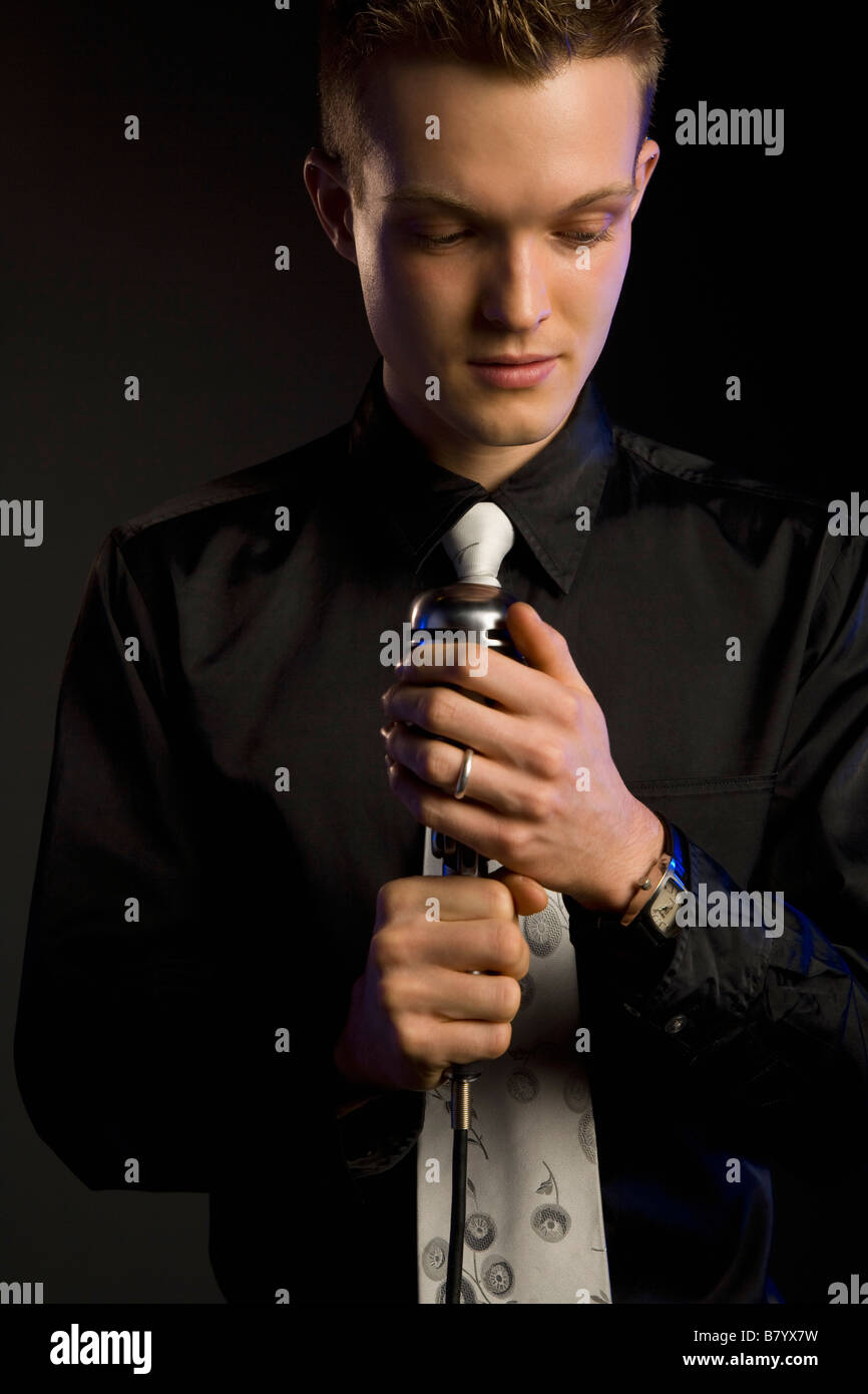 Young man with a microphone Stock Photo - Alamy