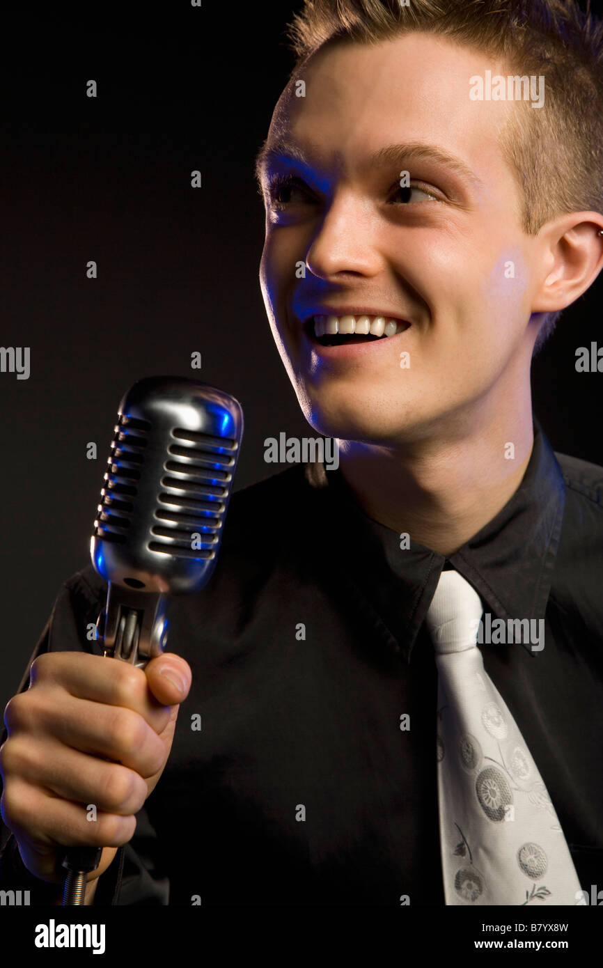 Young man with a microphone Stock Photo - Alamy