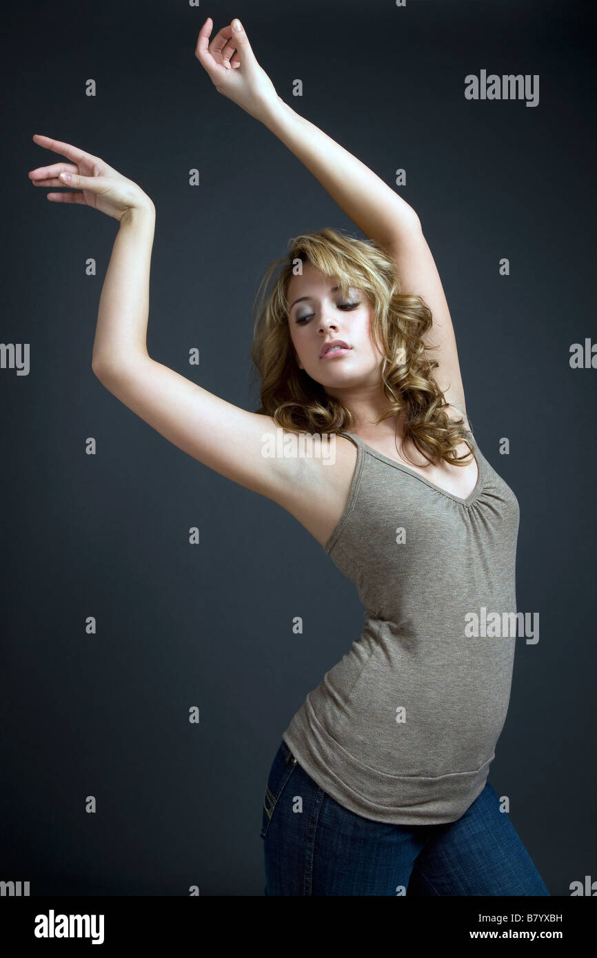 Woman with arms raised Stock Photo - Alamy