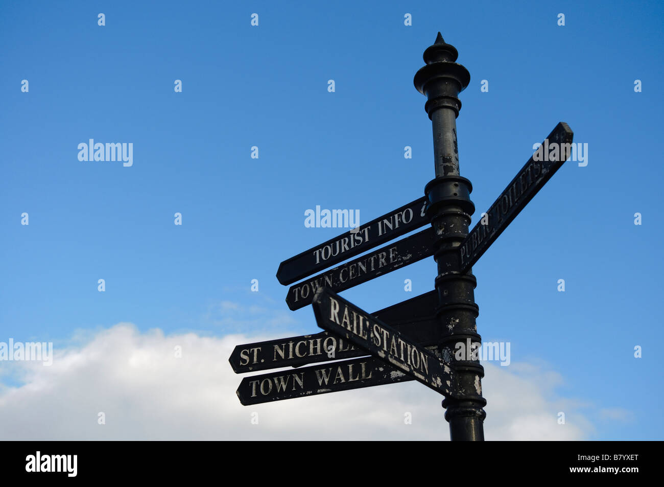 Direction signs against blue sky Stock Photo - Alamy